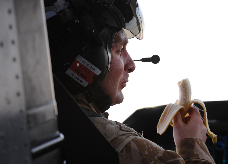 An Army Air Corps helicopter crew eating a banana on a flight in ...