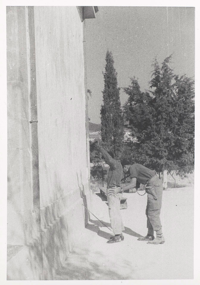 A soldier from 1st Battalion Middlesex Regiment in Cyprus searches a ...